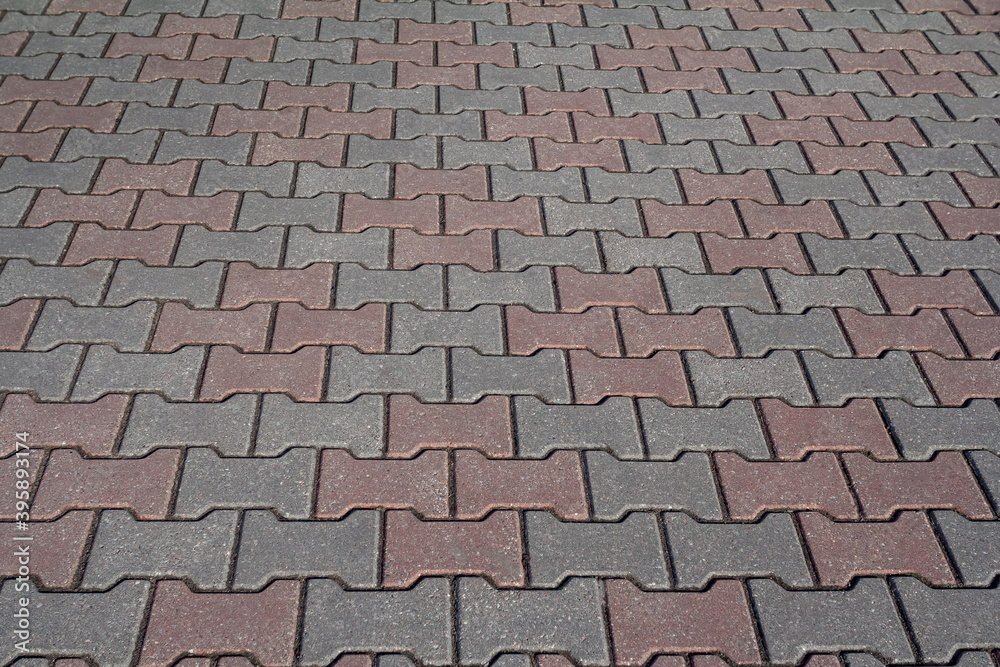 Red-gray paving stones on the sidewalk laid out in a checkerboard ...