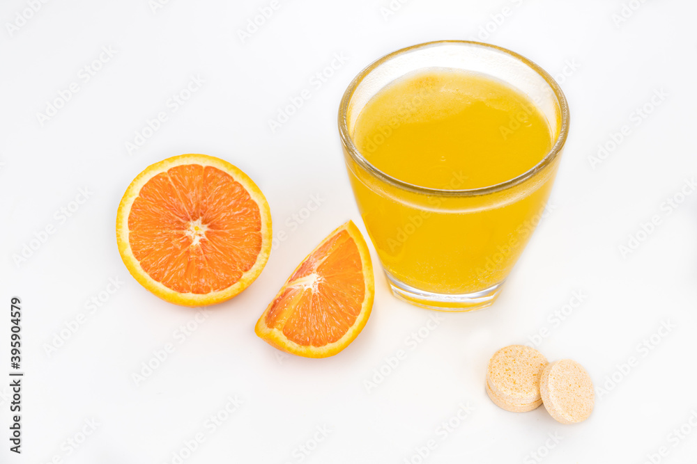Orange flavored vitamin c effervescent tablet dissolve in glass of ...