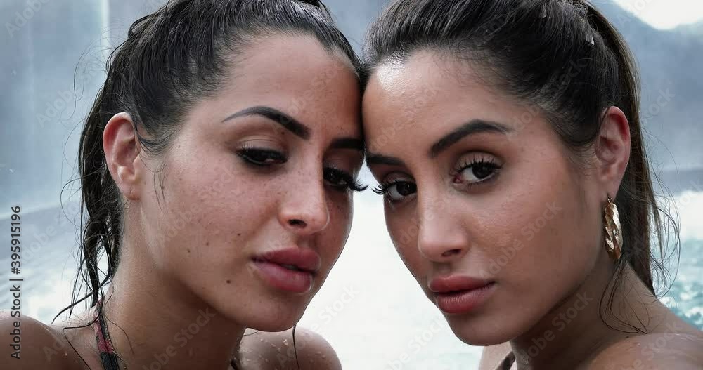 Close view of a portrait of women in a jacuzzi. Beautiful twin sisters ...