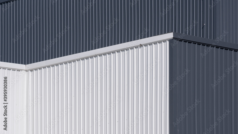 Low angle and side view of gray and white corrugated metal factory ...