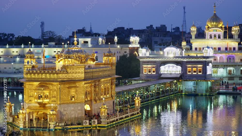 Sikh pilgrims visiting the Golden Temple aka Harmandir Sahib at dusk in ...