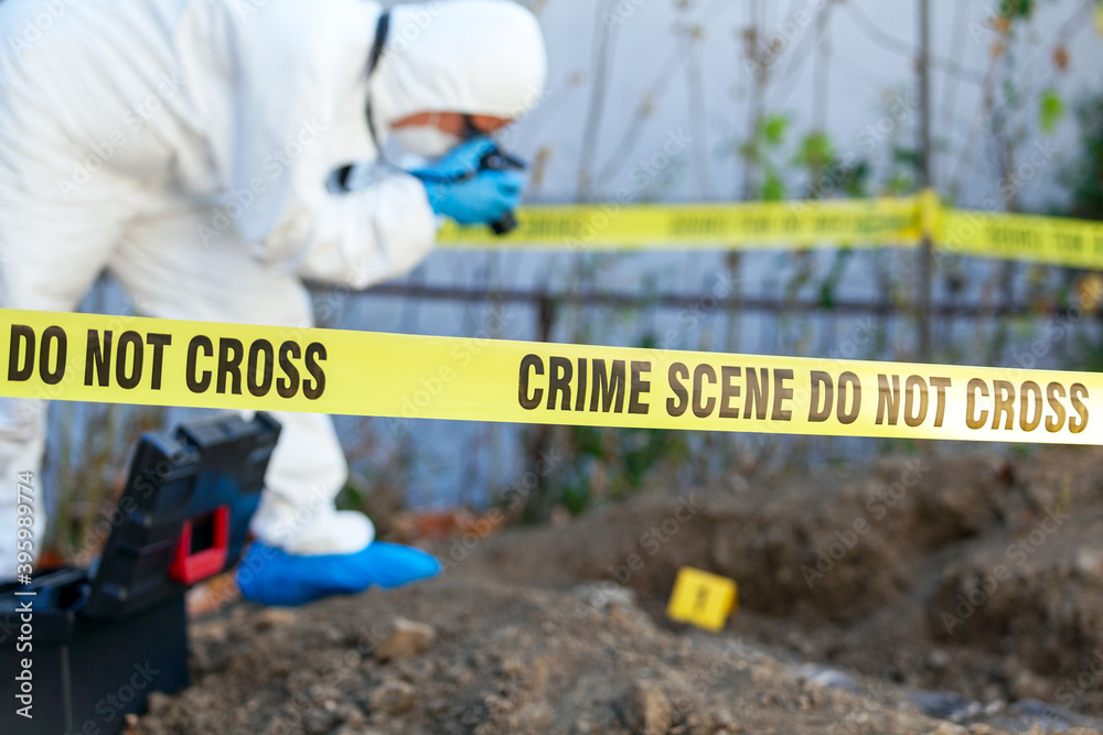 Crime scene investigation. Forensic science specialist working on human ...