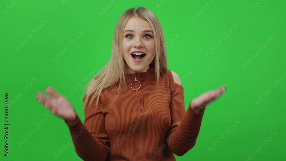 Joyful pretty blonde in casual wear goofing off and taking fun over ...