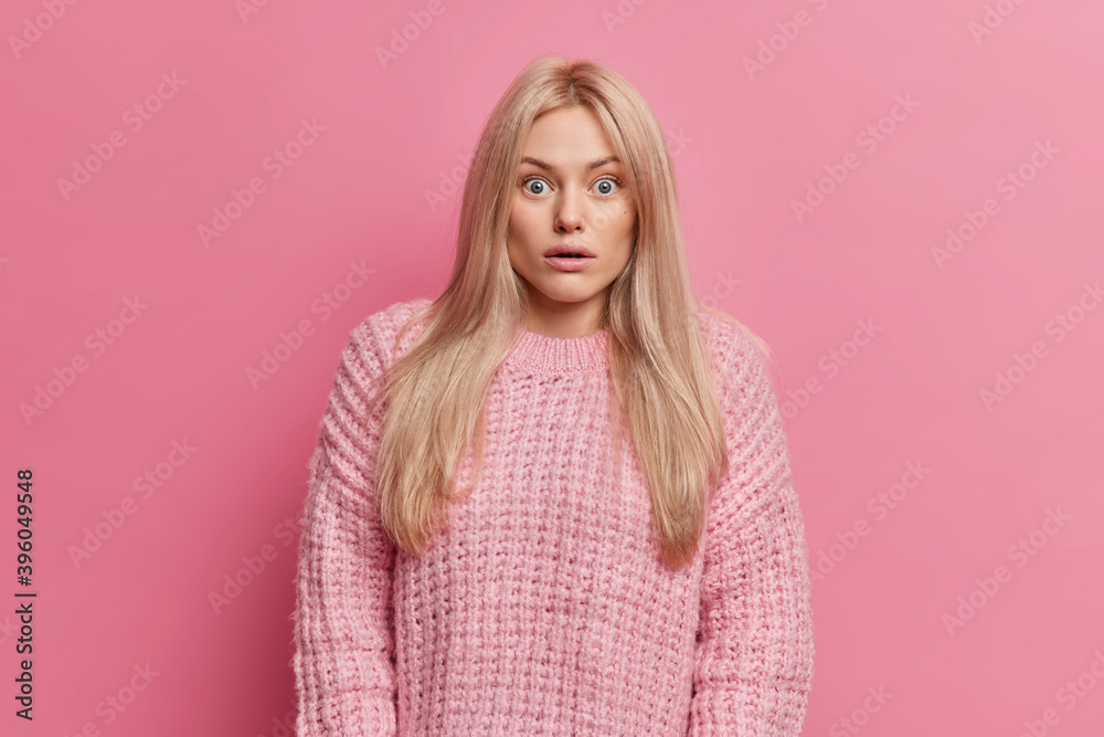 Shocked blonde young European woman has stupefied face expression ...