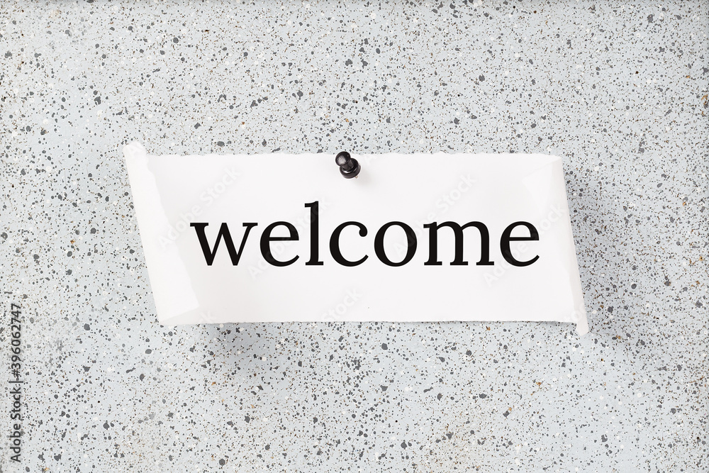 WELCOME text on notice board on top of office desk. Business finance ...