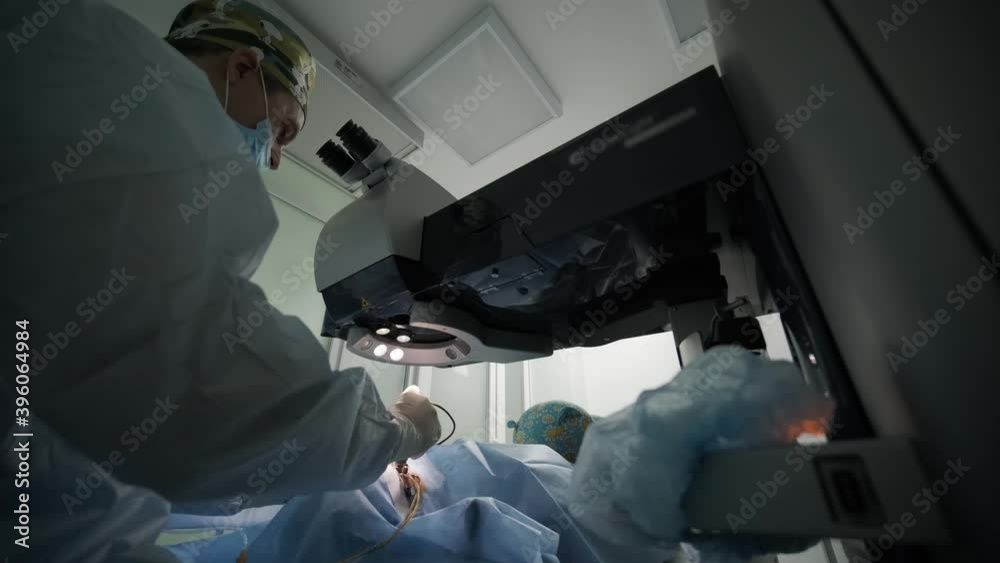 Laser vision correction. A patient and team of surgeons in the ...