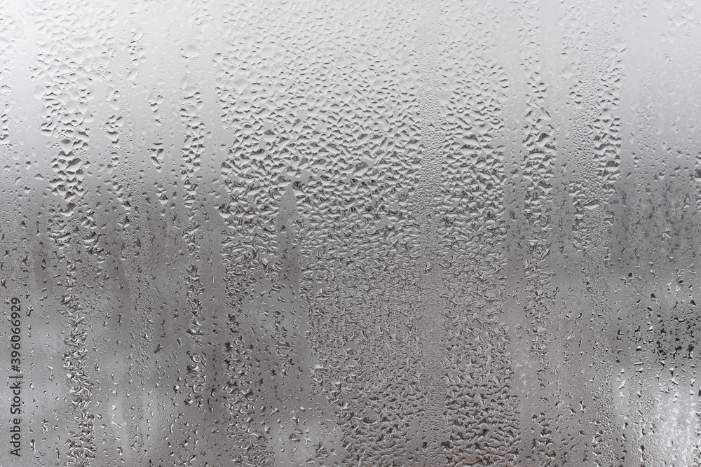 Close up for misted glass with droplets of water draining down ...