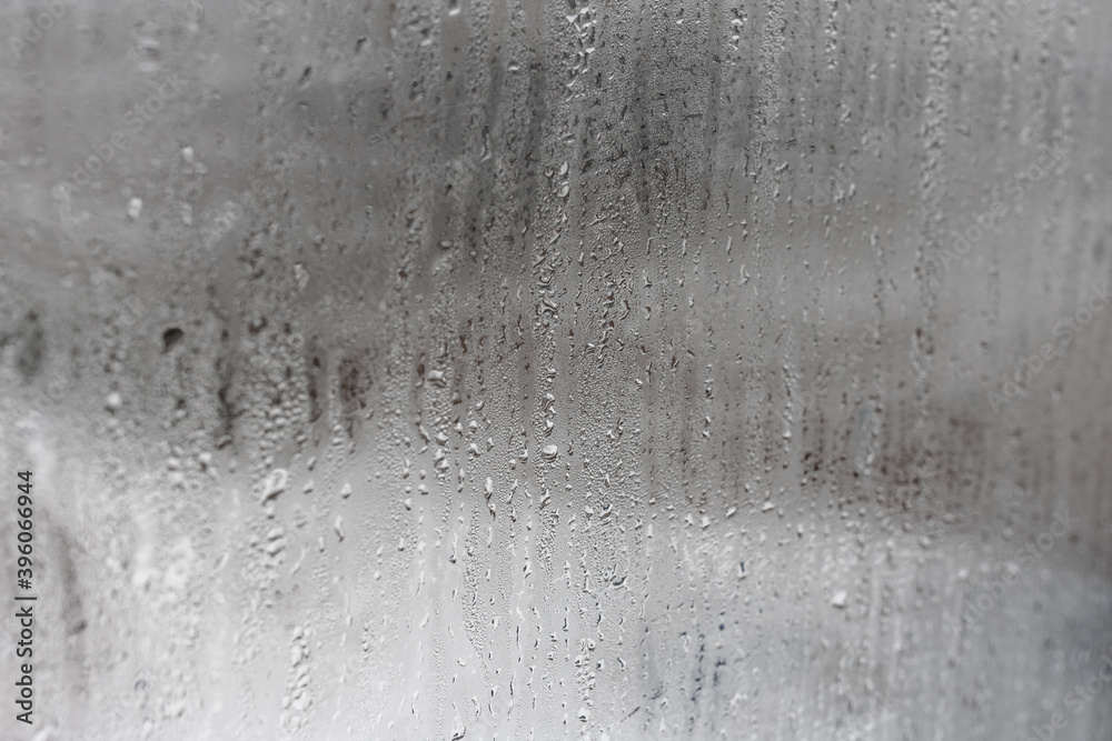 Close up for misted glass with droplets of water draining down ...