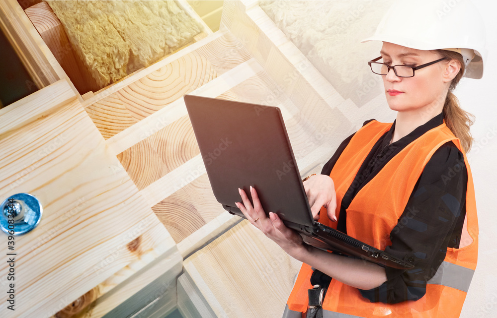 Woman engineer on background of timber beams. Wooden beam is connected ...