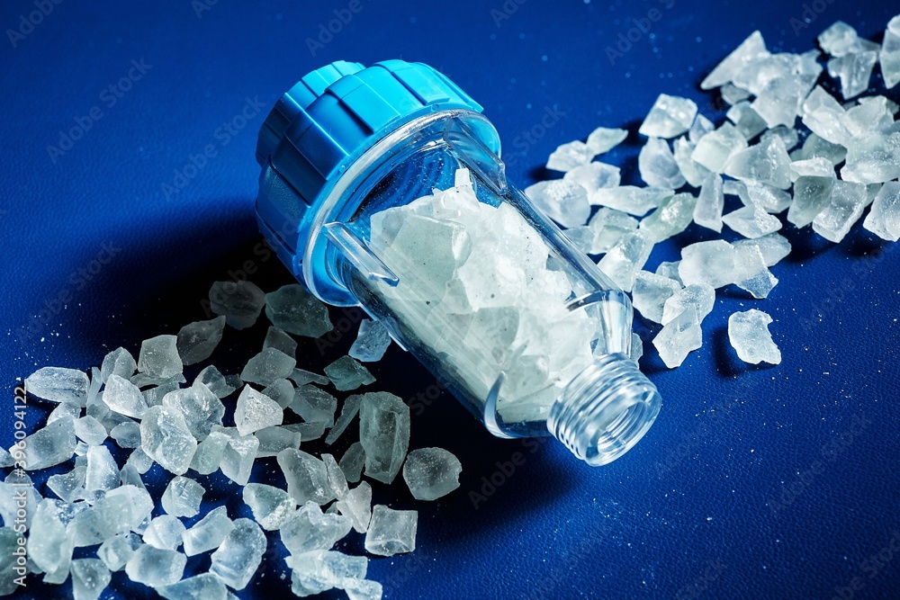 water filter with a crumb of salt crystals on a blue background Stock ...