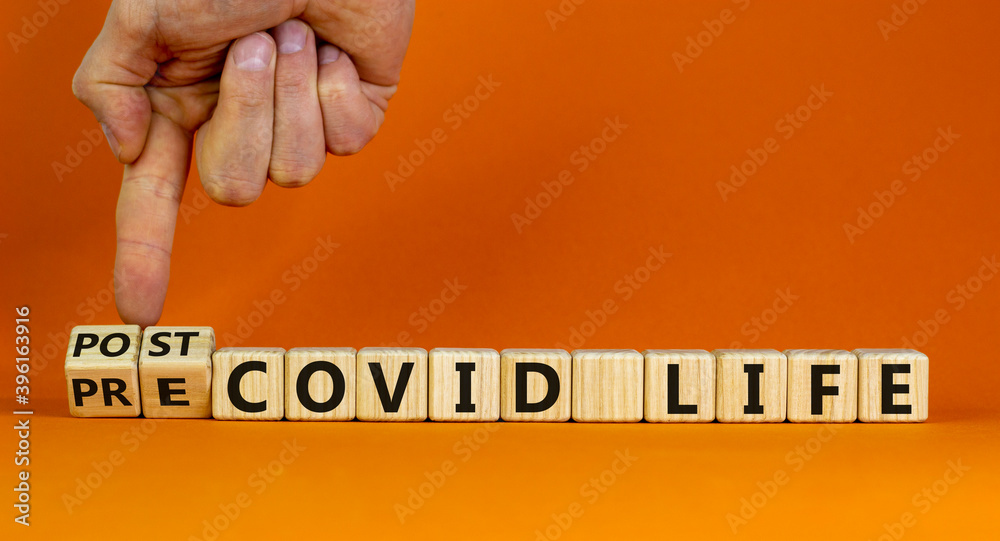 Symbol for a post-covid life. Male hand turns cubes and changes the ...