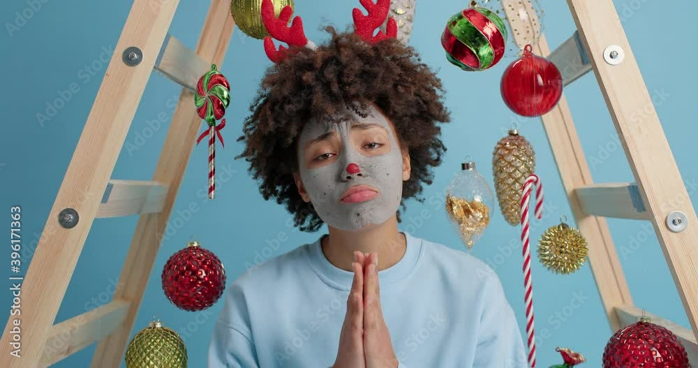 Begging woman has image of christmas reindeer keeps palms pressed ...