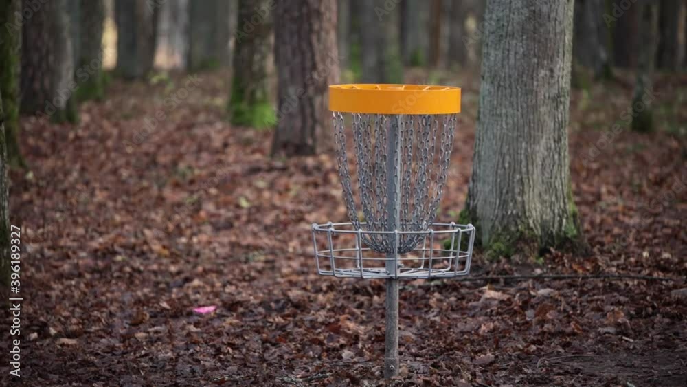 Video Stock Disc Golf target basket yellow in autumn forest with moving ...