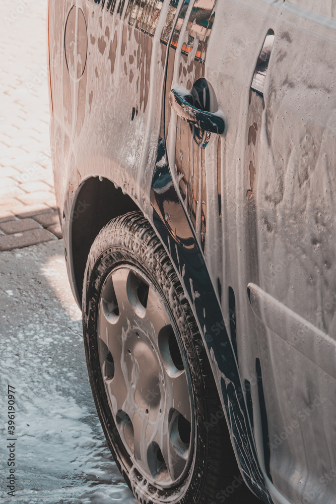 Foam on the car, car wash, self-service at the car wash, washing the ...