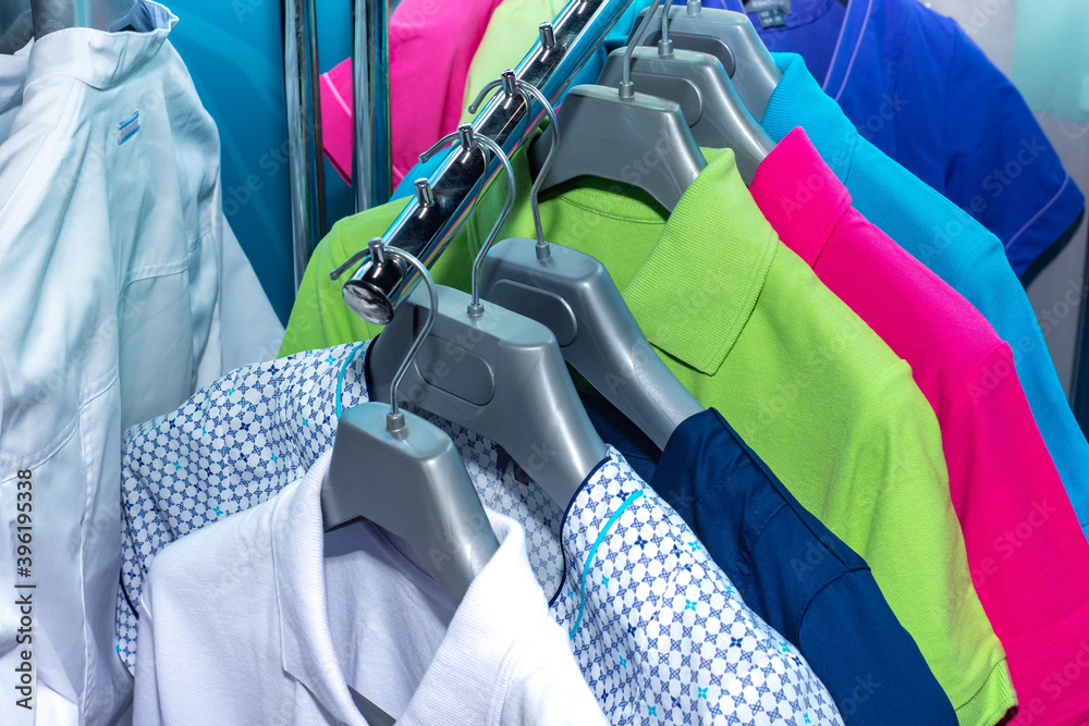 Hanger with models of medical clothing. Uniforms for doctors and nurses ...