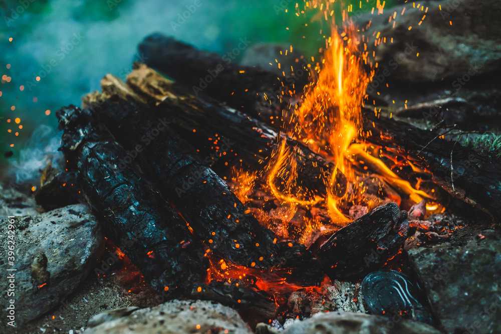 Vivid smoldered firewoods burned in fire close-up. Atmospheric ...