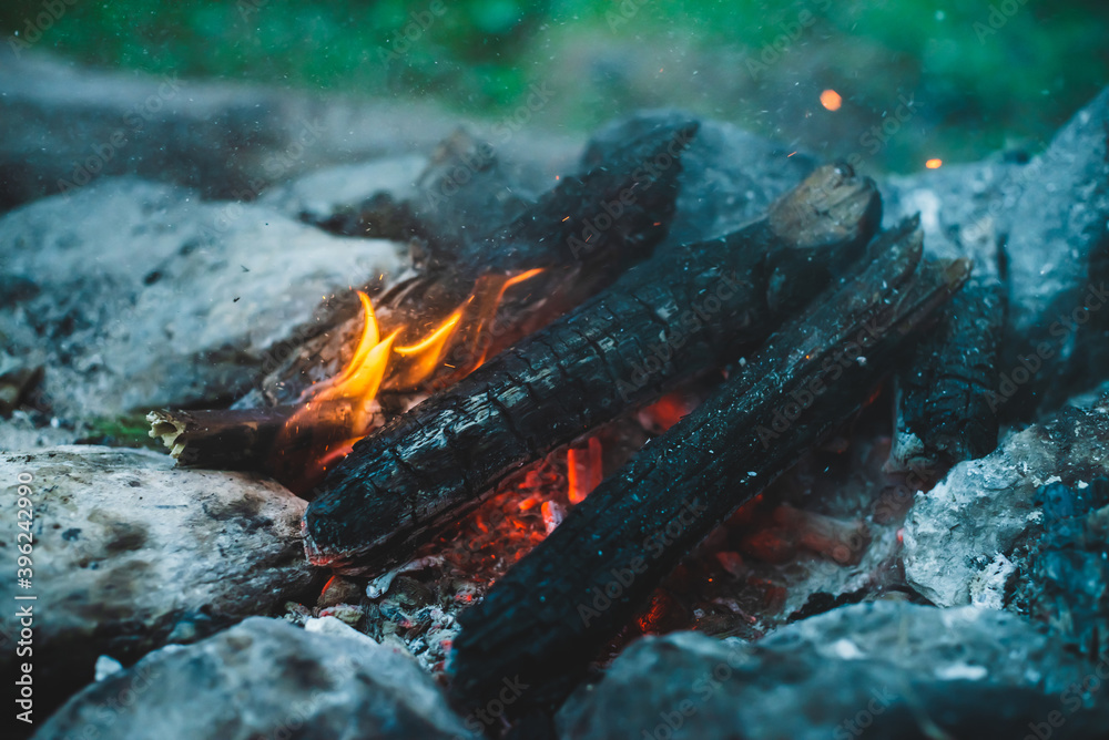Vivid smoldered firewoods burned in fire close-up. Atmospheric warm ...