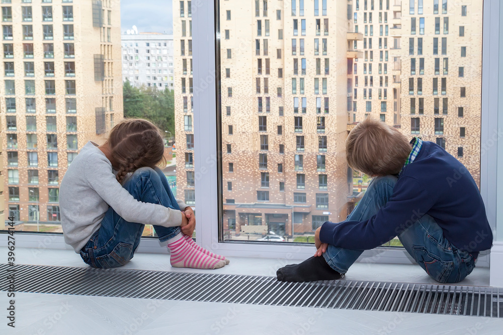children sit on floor by window and cannot go outside during quarantine ...