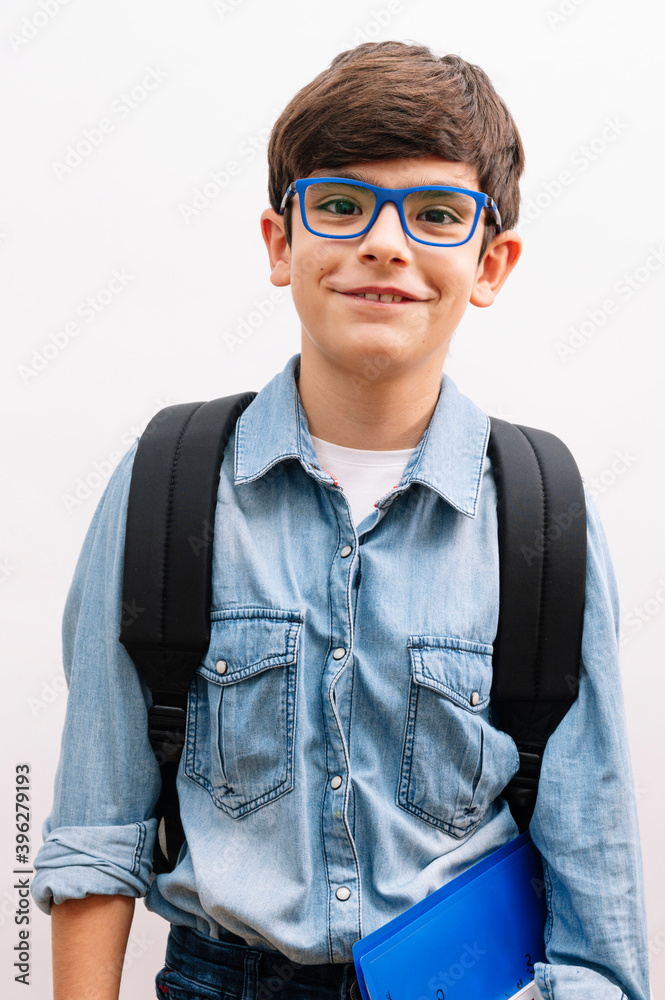 Beautiful student kid boy wearing backpack holding books over isolated ...