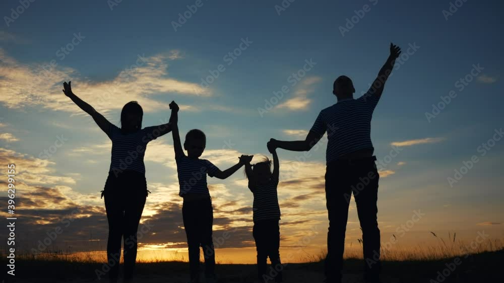 happy family raise their hands up in the park silhouette. family ...