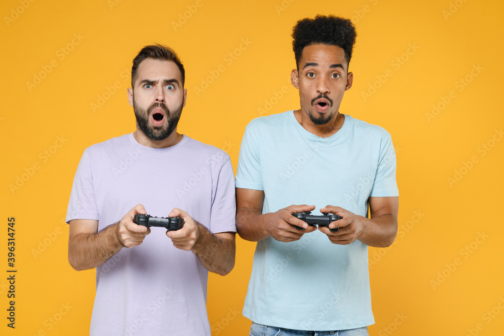 Shocked amazed young friends european african american men 20s wearing ...