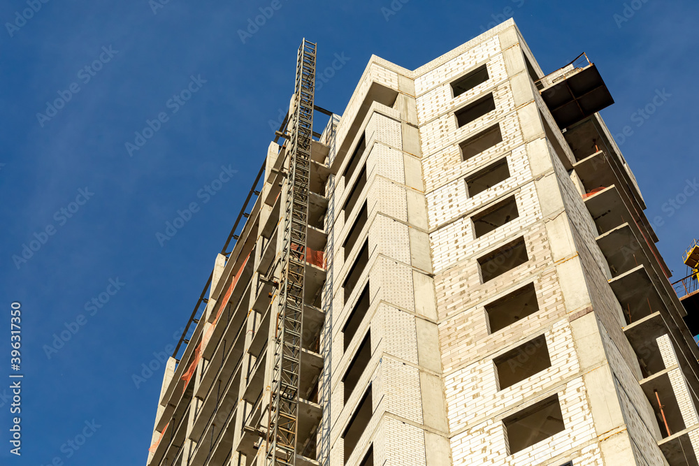 Construction of a typical multi-storey building against the blue sky ...