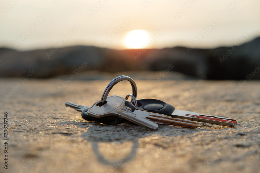 A lost keys on the ring on the rock illuminated with sun rays, blurred ...
