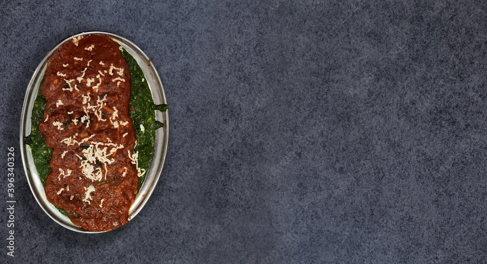 Vegetarian chilli milli and spicy masala gravy. Top view on a dark wood ...