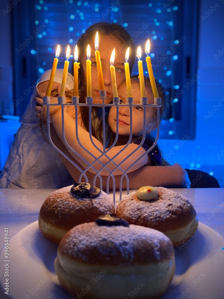 Children celebrate Hanukkah. Jewish festival of lights. Children light ...
