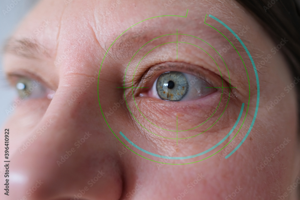 gray eye with spots on the iris, wrinkles on the eyelids close up ...