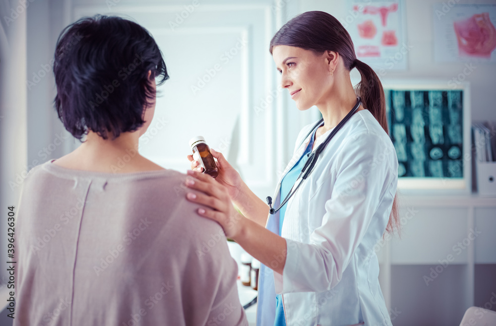 Beautiful female doctor explaining medical treatment to a patient ...