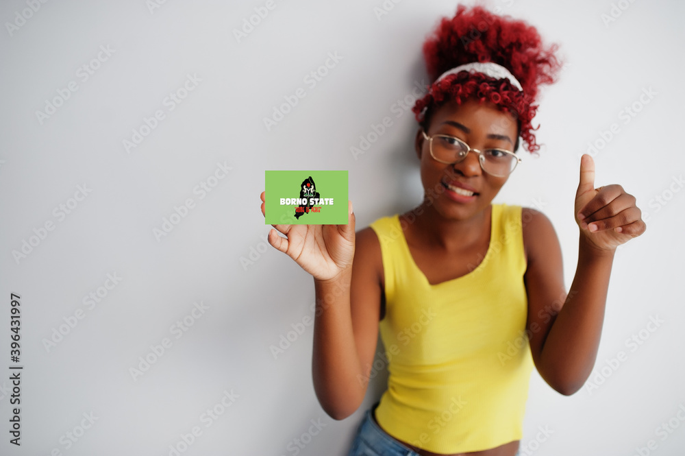 African woman with afro hair hold Borno flag isolated on white ...