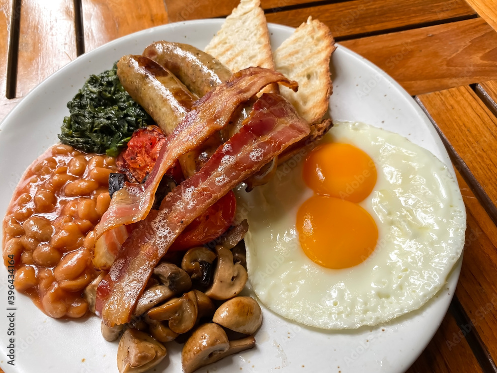 Breakfast with Cumberland sausages, fried eggs sunny side up, sautéed ...