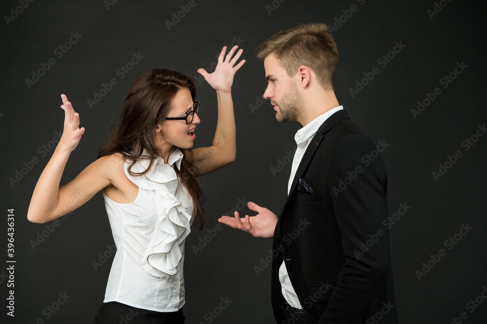 Disagreement among colleagues. Emotional woman and man fight dark ...