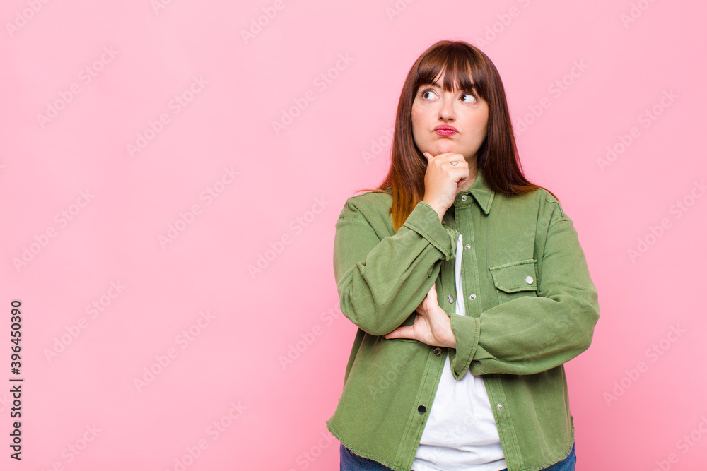 overweight woman thinking, feeling doubtful and confused, with ...