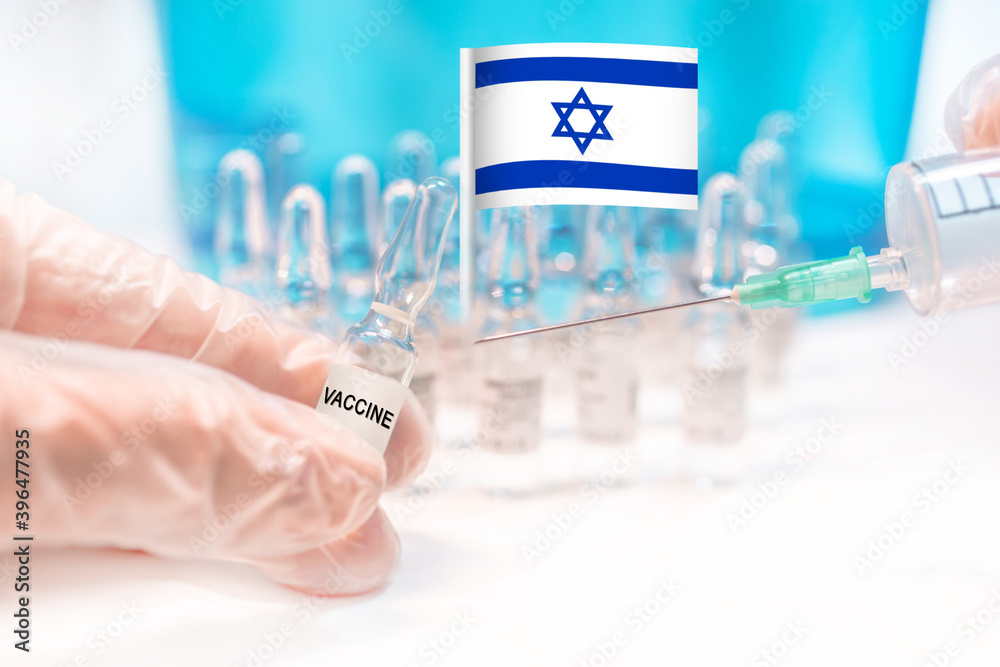 Hands holding a vaccine vial and a syringe with rows of the same ...