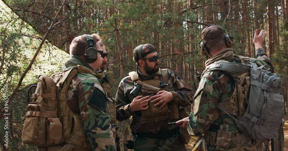 A Group Of Middle Aged Bearded Soldiers In Uniforms And Tactical Vests Discusses The Action Plan