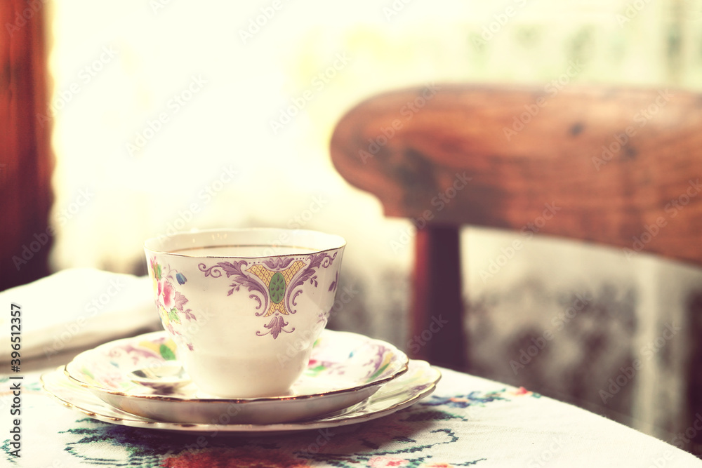 Retro photo of elegant tea set on a section of a round table with a ...