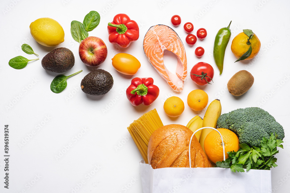 Healthy food background. Vegetables, fruits, bread, pasta and salmon in ...