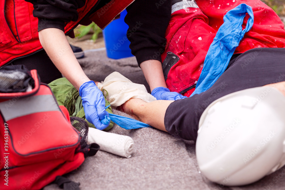 Workplace hand injury. First aid after accident on work at construction ...