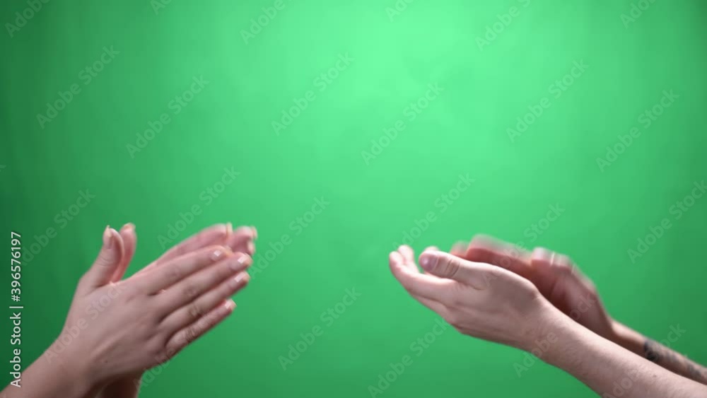 Hands are clapping on green screen background. Female and male hands ...