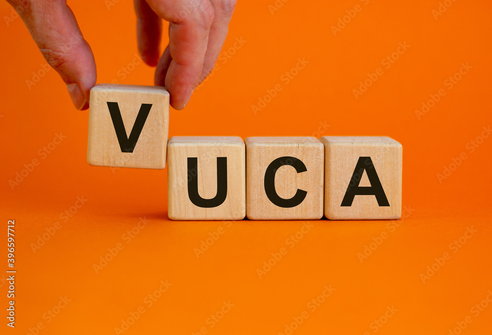VUCA symbol. Wooden cubes with word 'VUCA - volatility, uncertainty ...
