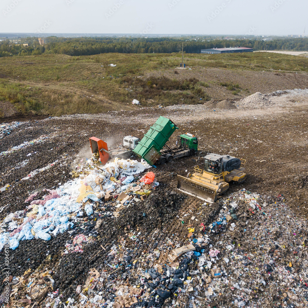 Top drone view of dump with different types of garbage. Trucks ...