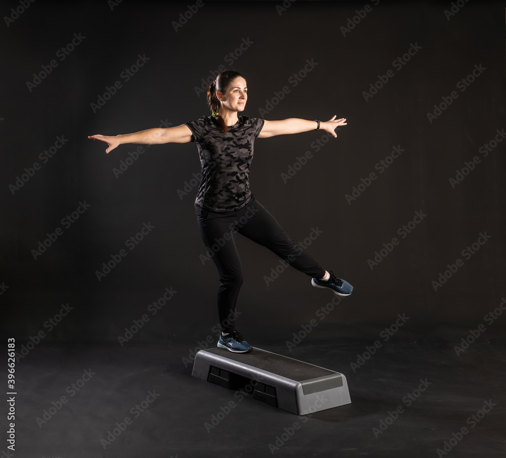 Fitness woman on step platform, doing exercises. Going in for sports on ...