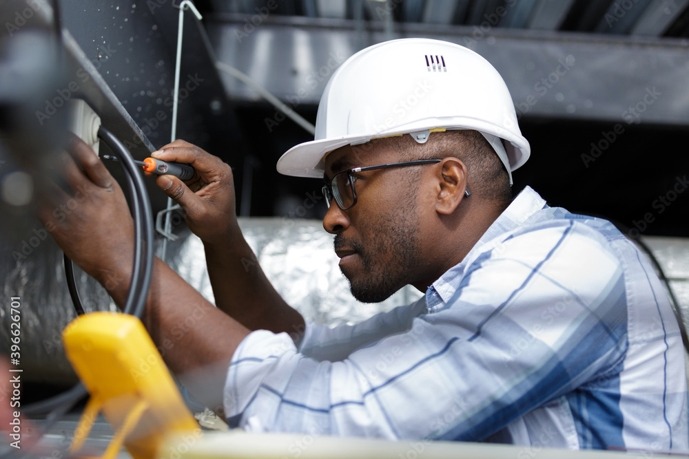 Photo Art Print electrician fitting a cable for ceiling light auremar
