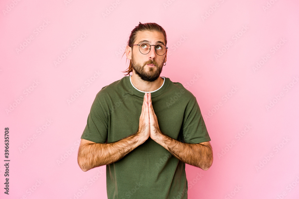 Young man with long hair look praying, showing devotion, religious ...