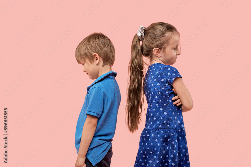 Brother and sister quarrel and stand with their backs to each other. A ...