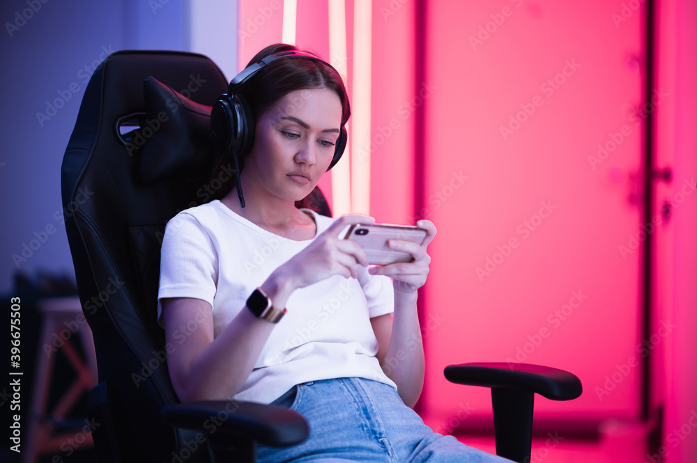 Cybersport gamer playing mobile game on the smart phone sitting on a ...