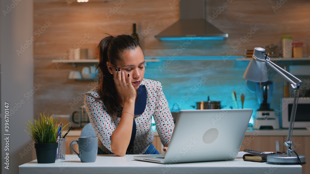Exhausted remote woman napping on chair waking up working on laptop ...