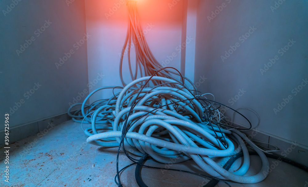 Pile of cables on floor in new building. Electricity installation and ...